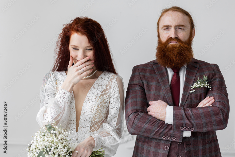 Beautiful red-hair bride in a white wedding dress and bouquet of ...