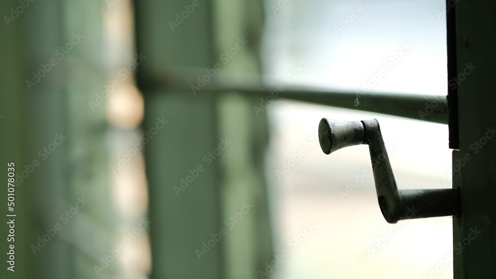 Hand crank used to open the shutters of the window openings. Stock ...