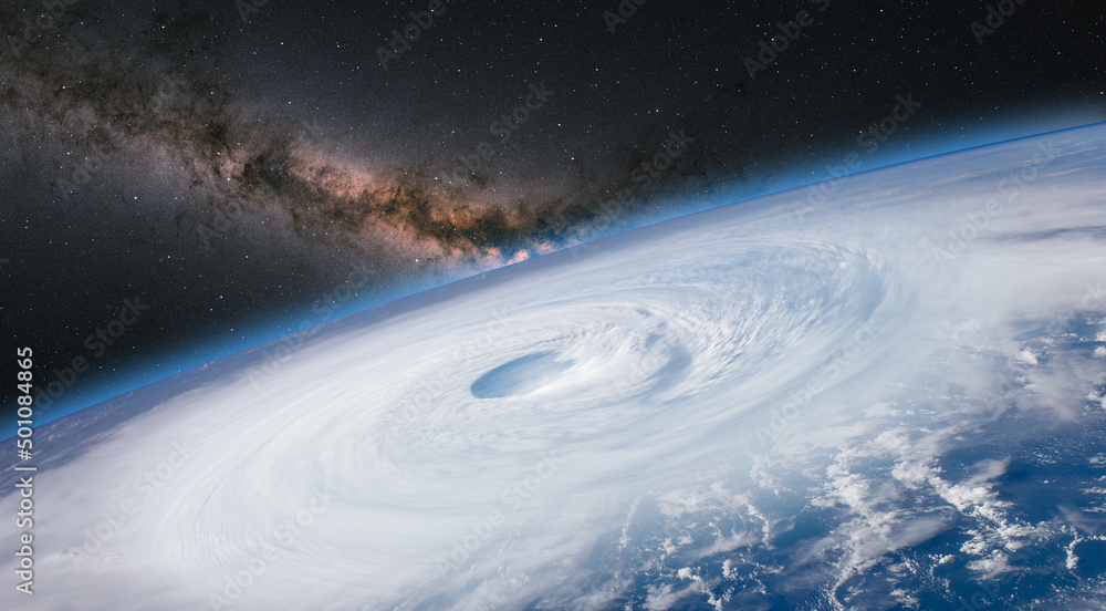 Giant hurricane seen from the space with milky way galaxy at sunset ...