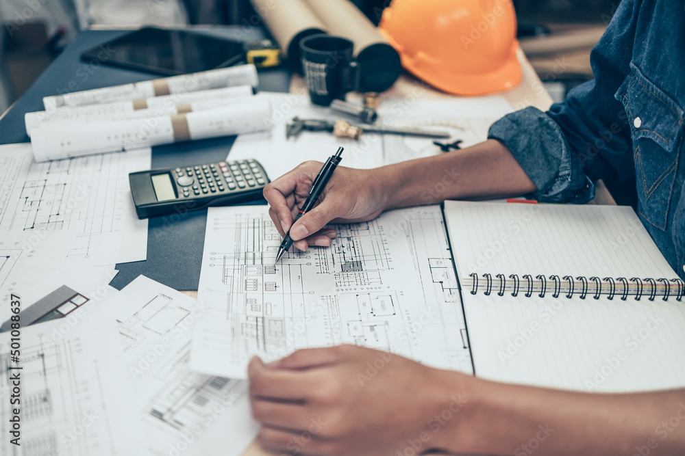 Architect engineer use pen drawing design working on blueprint. House ...