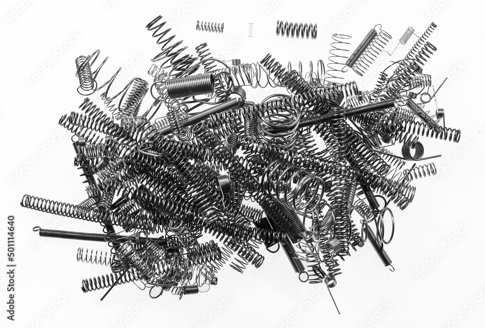 Pile of metal flexible coiled springs from spiral wire of various sizes ...