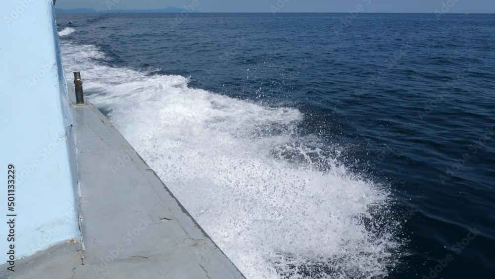 Sea water splash and break to spray and white foam by side of boat ...