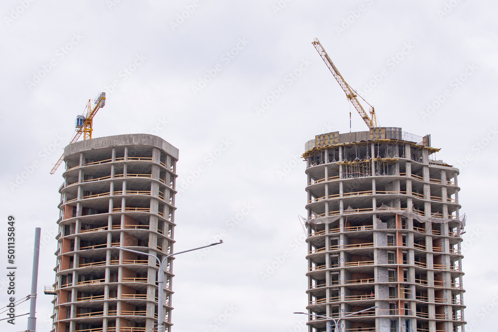 Construction of a high-rise building with a crane. Construction of ...
