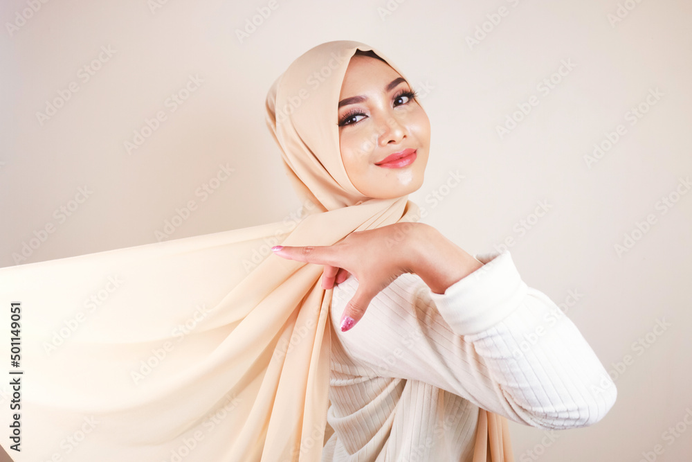 Muslim woman wearing traditional wear and hijab isolated on white ...