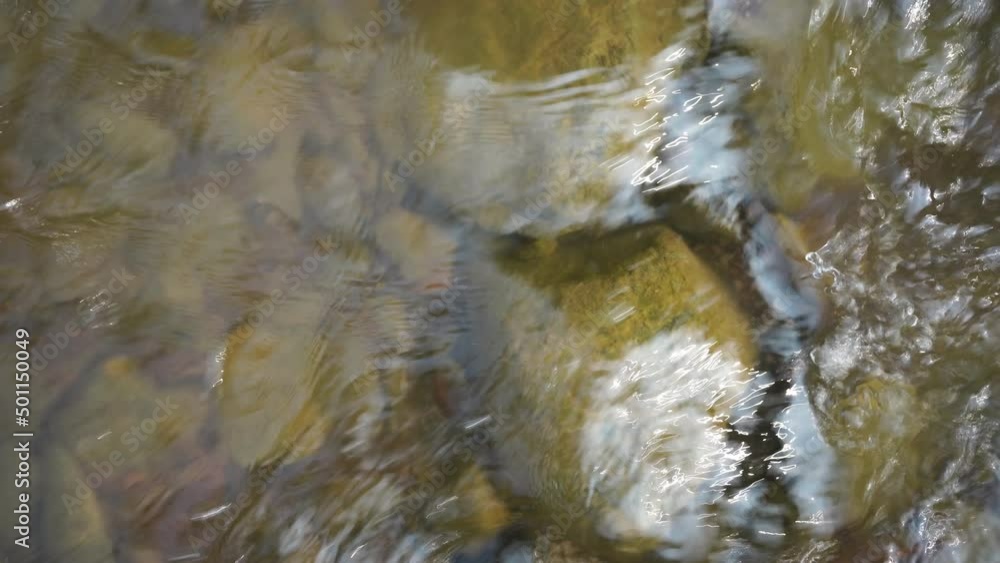 Natural canal water flows across rocks, a natural body of water in the ...