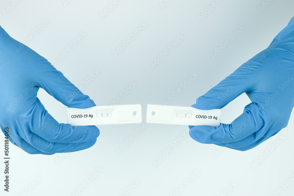Medical personnel showing Covid-19 positive and negative test result ...