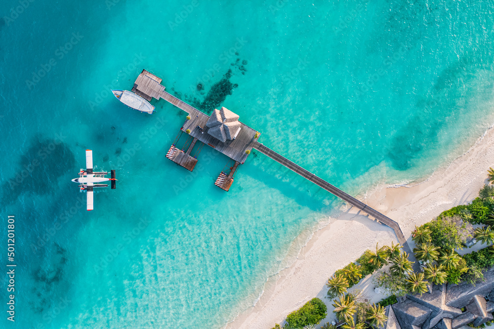 Beautiful aerial view of Maldives shore, jetty villa seaplane top view ...