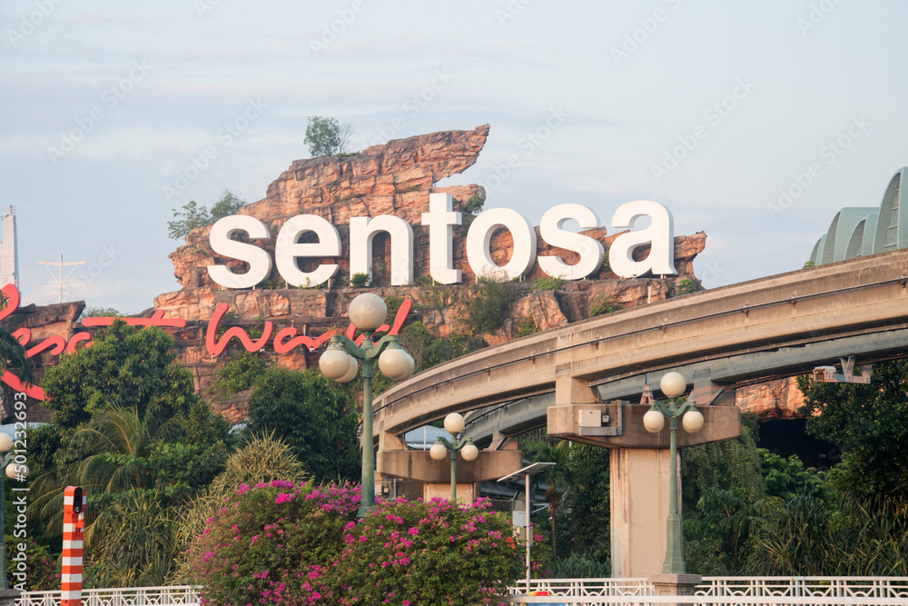 The sign of the Sentosa Island surrounded by tropical trees, Singapore ...