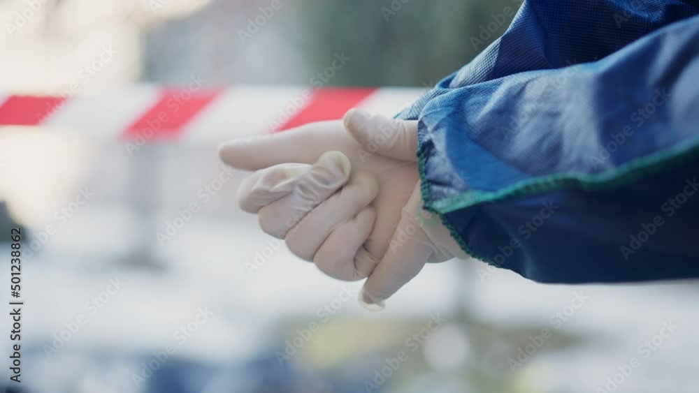 Female Caucasian Hands Putting On White Gloves With Red And White