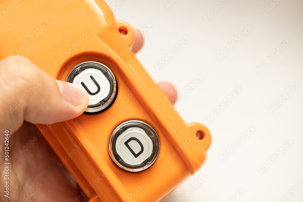 Hoist push button switch in isolated. hand holding overhead cranes ...