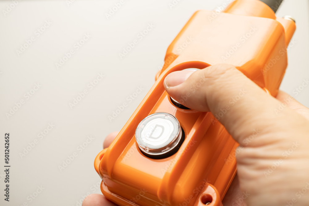 Hoist push button switch in isolated. hand holding overhead cranes ...