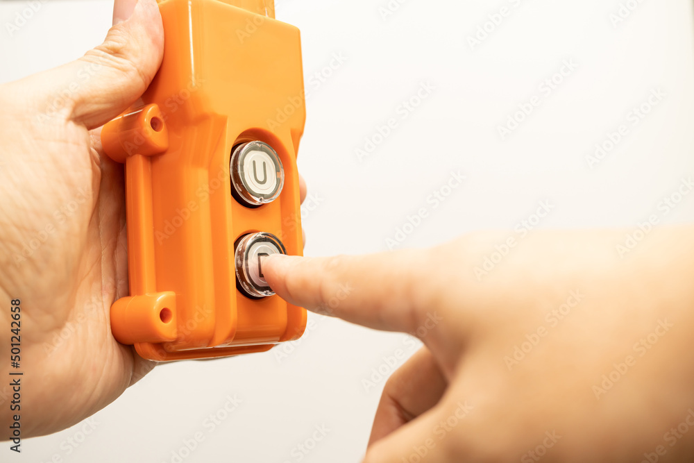 Hoist push button switch in isolated. hand holding overhead cranes ...