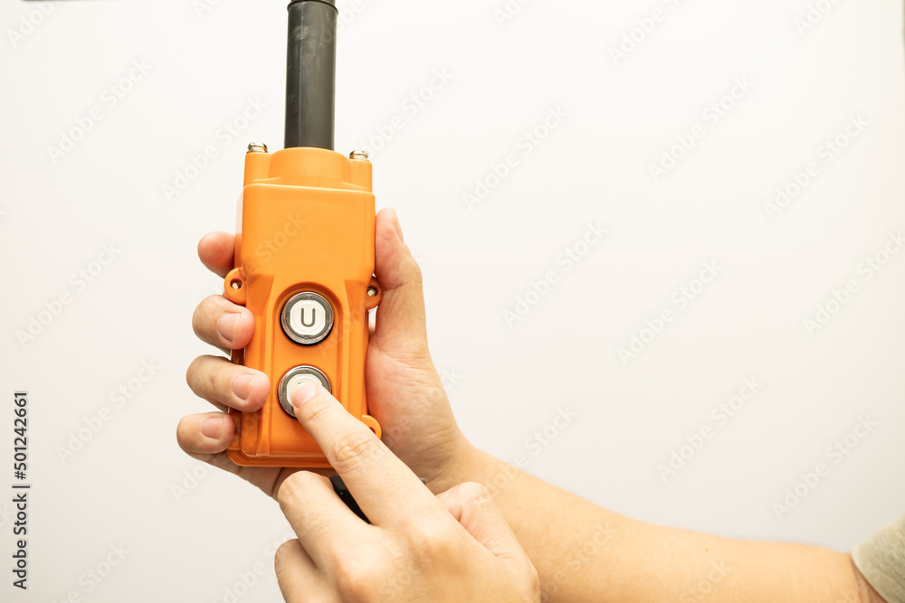 Hoist push button switch in isolated. hand holding overhead cranes ...