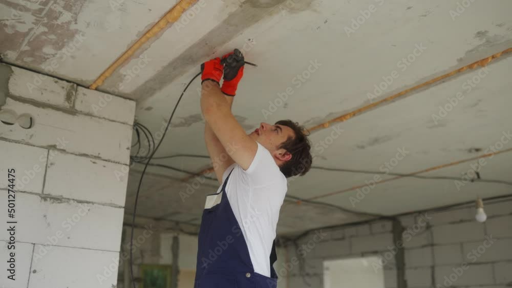 Electrician laying wiring cable, mounting electricity lines in the ...