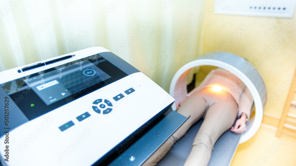 Magnet therapy system. Patient on a treatment bed with Magnetic Field ...