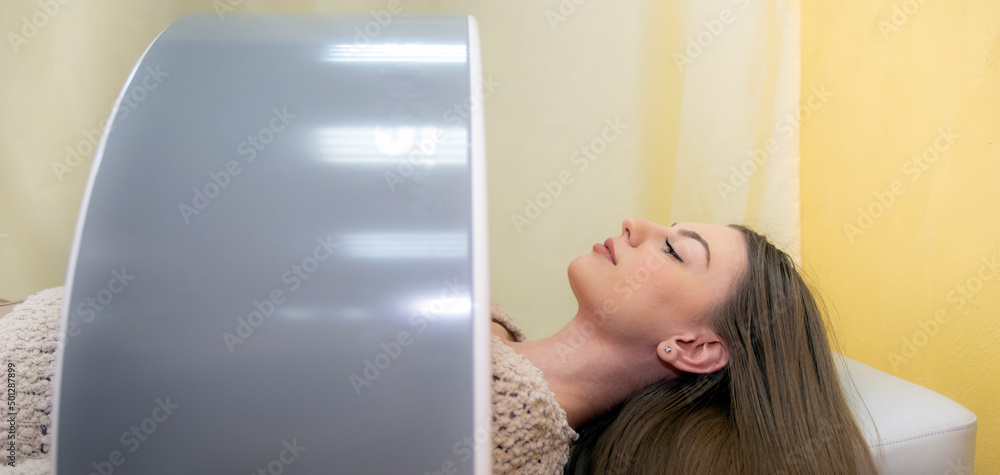 Magnet therapy system. Patient on a treatment bed with Magnetic Field ...