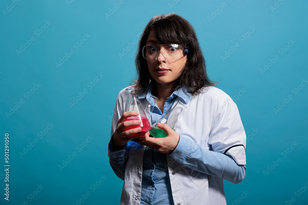 Cautious professional chemistry laboratory worker on blue background ...