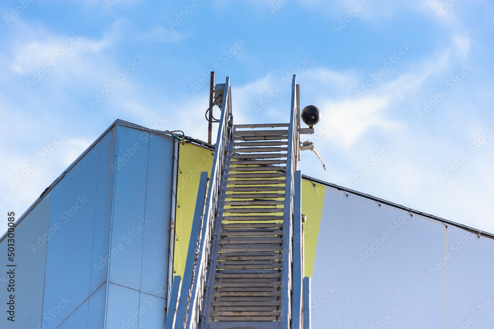 Fire ladder leading to the roof of a building, extinguishing a fire in ...
