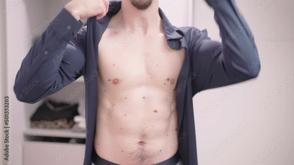 Headless muscular man dressing up elegant blue shirt in bedroom 4K ...