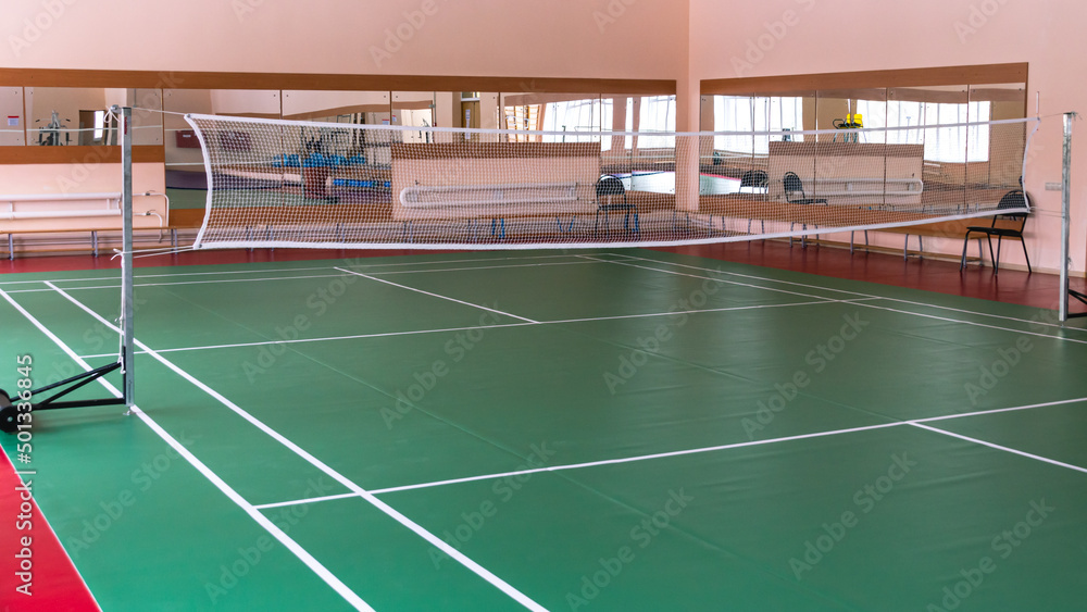 Sports hall with a white woven net. Badminton court. Sports hall for ...