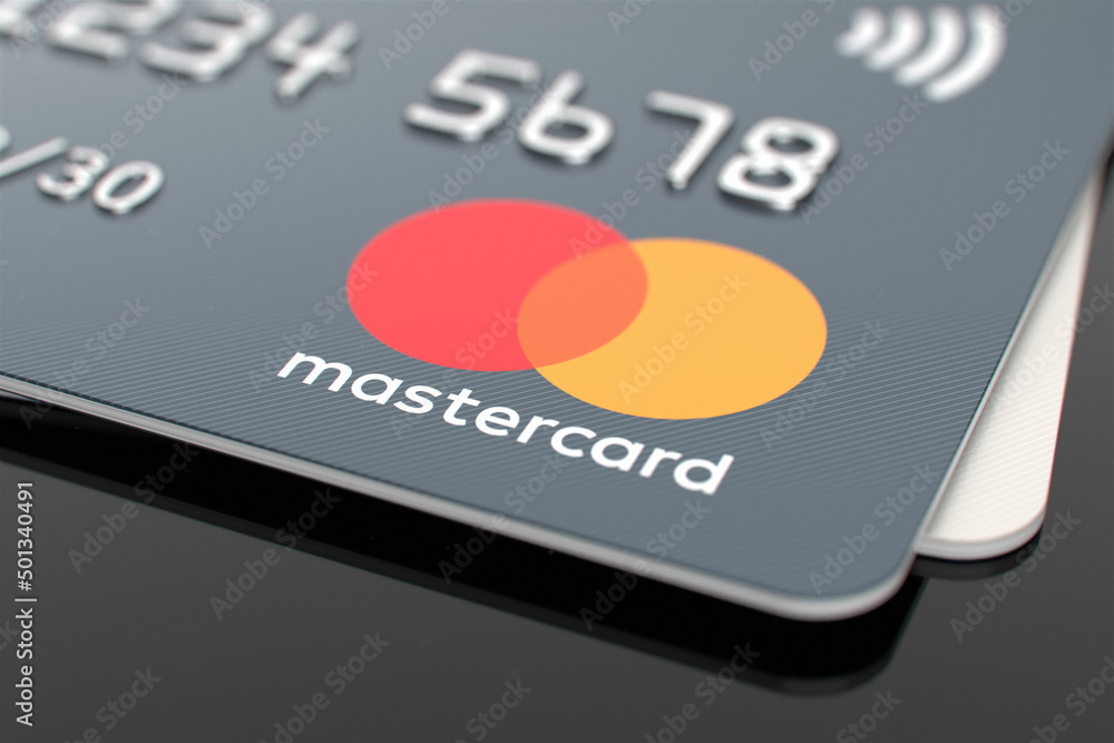 Credit card Mastercard on a black shiny surface. Logo of the payment ...