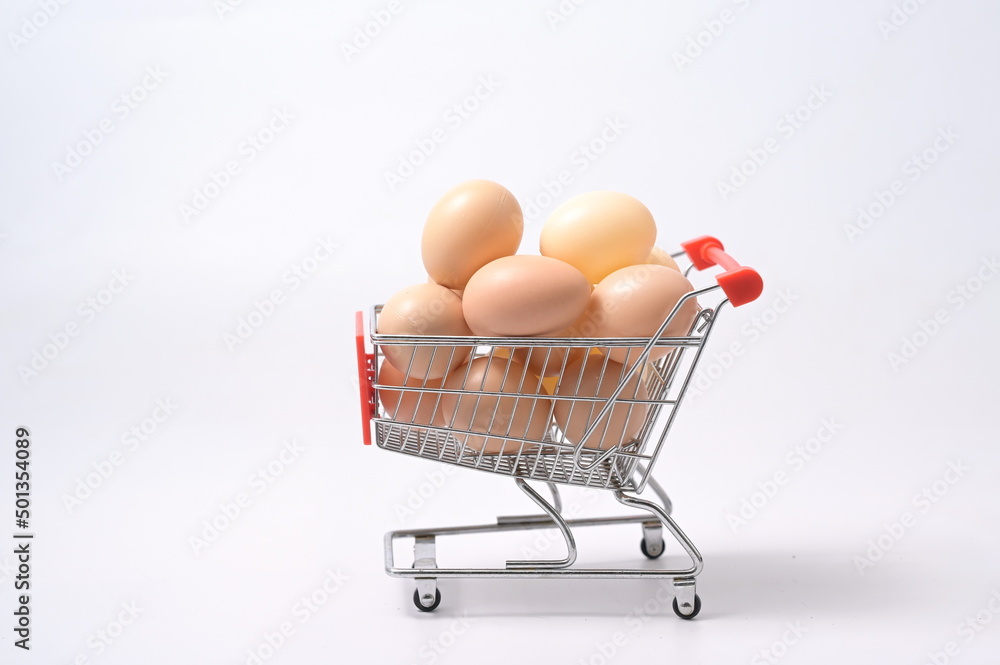 The eggs in mini shopping trolley fabricated from steel. The reddish ...