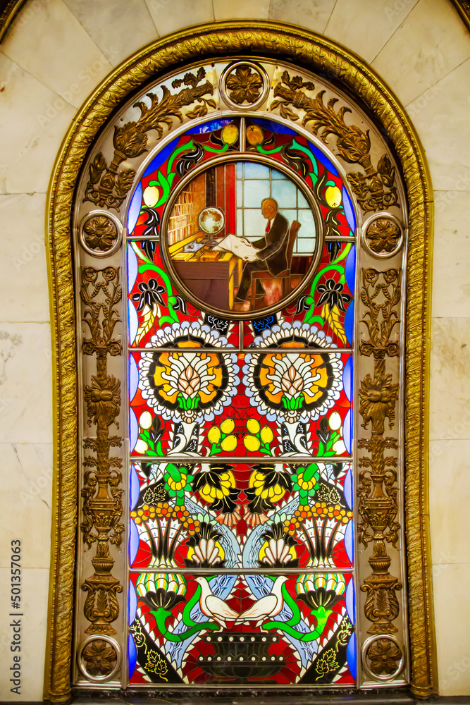 Illuminated stained glass window with a beautiful flower pattern of a ...