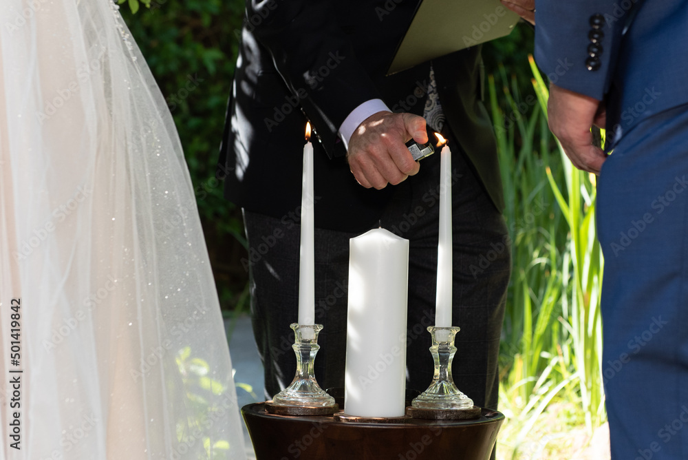 Lighting the individual candles for the bride and groom that will ... Lighting the individual candles for the bride and groom that will ...