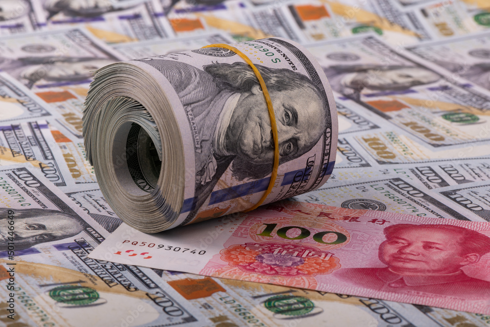 A stack of 100 US dollar bills and a 100 Chinese yuan bill Stock Photo ...