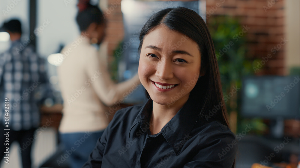 Portrait Of Smiling Asian Software Developer Looking At Camera In Cloud Computing Development