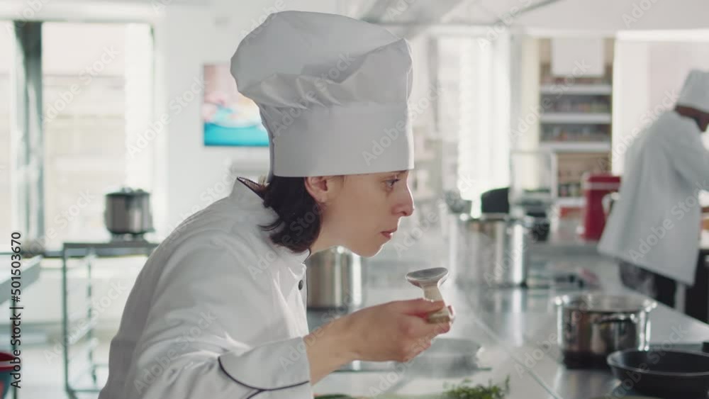 Female chef tasting liquid sauce on stove to make cuisine dish, cooking ...