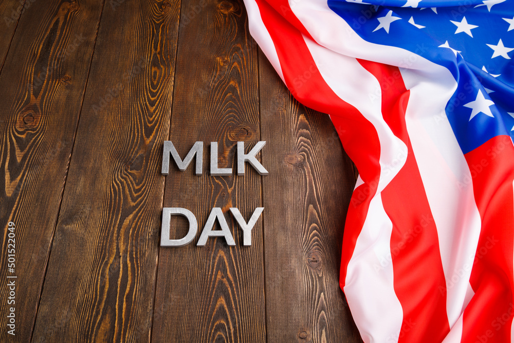 the word MLK day laid with silver metal letters on wooden surface with ...