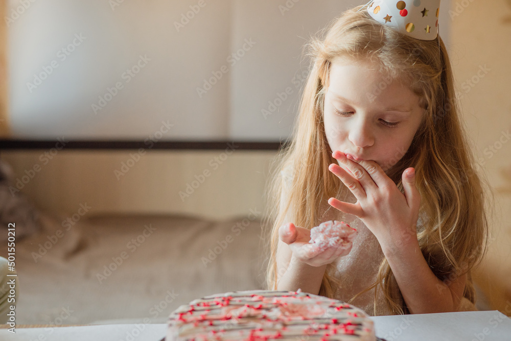 little girl, birthday girl in festive cap, child without hesitation ...