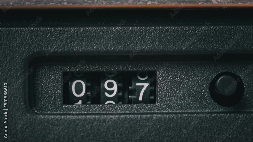 Old vintage mechanical reel counter. Close-up of turning digit ...