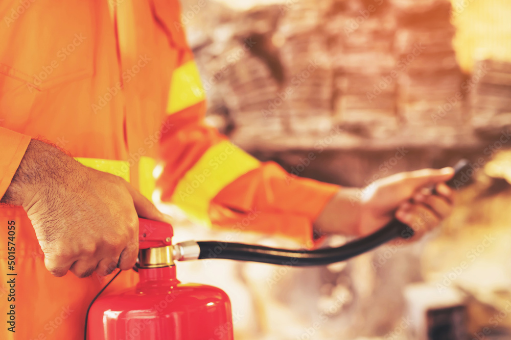 hand presses the trigger fire extinguisher available in fire ...