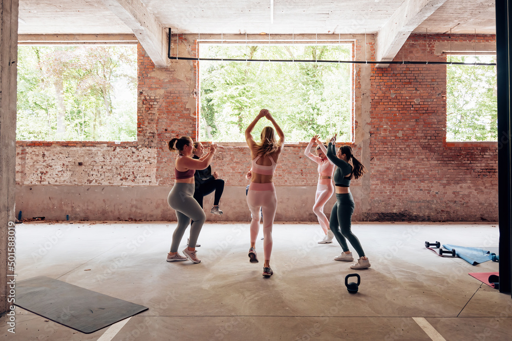 group of women of different body shapes doing power dance together ...