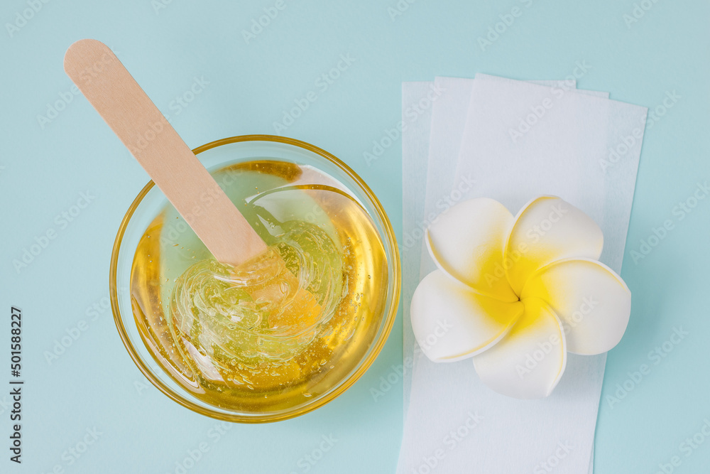 Liquid yellow sugar paste, wooden spatula, depilatory strips and flower ...