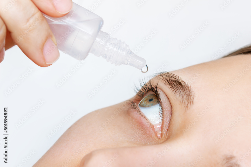 Cropped shot of woman dripping her eyes with medicinal drops natural ...