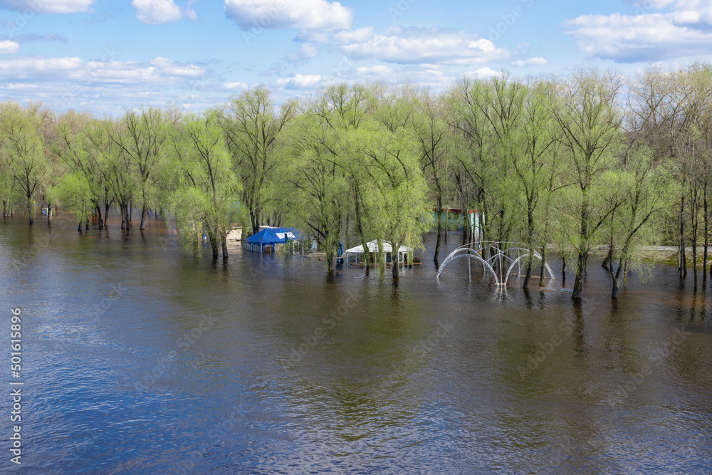Spring flood on a river in Europe as a result of seasonal snowmelt and ...