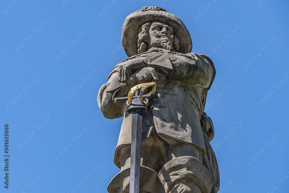 Stone statue of Jan van Werth (1884) on a gothic column. The seated ...