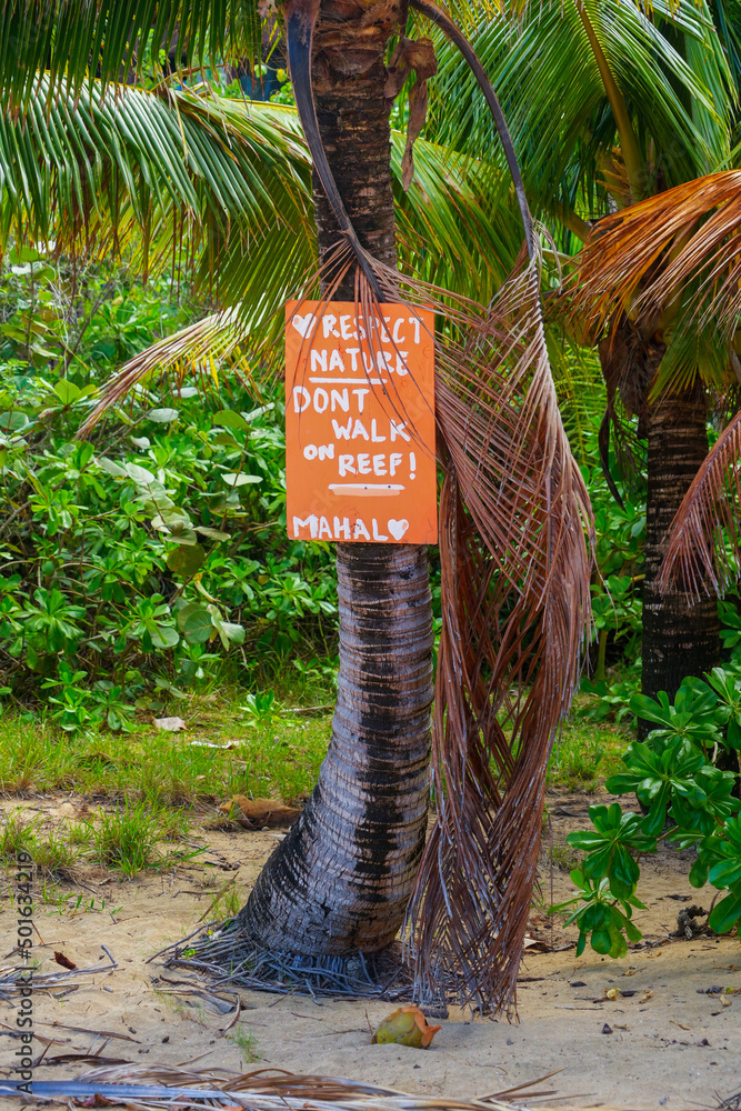 Handwritten sign asking to respect nature and not to walk on the reef ...