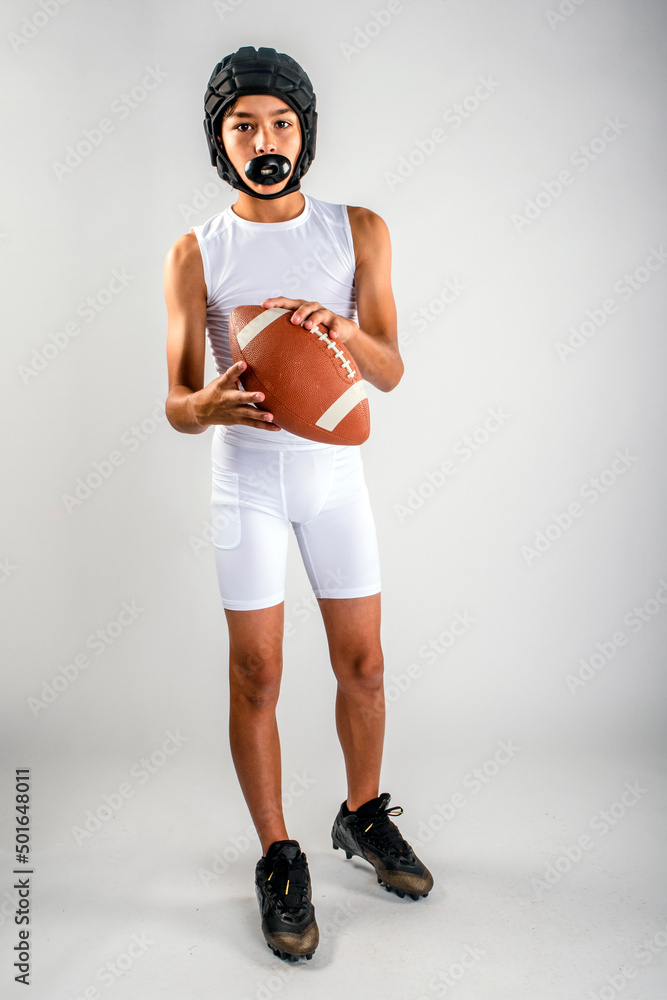 Youth male 7-on-7 football player wearing his soft shell helmet and ...