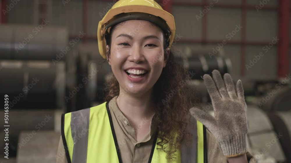 Happy Asian woman engineer in uniform wearing yellow safety hard hat ...