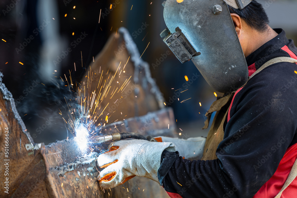 Welder in Iron mask helmet welds steel welding, Industrial worker at ...