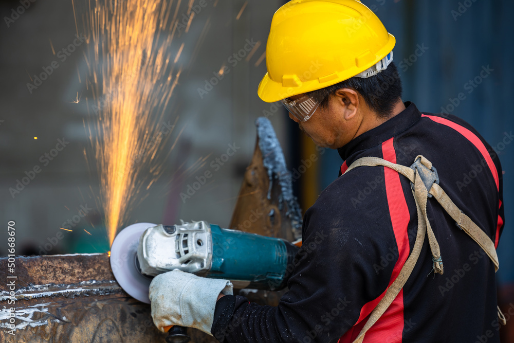 Industrial worker using angel grinder cutting metal, Electric grinder ...