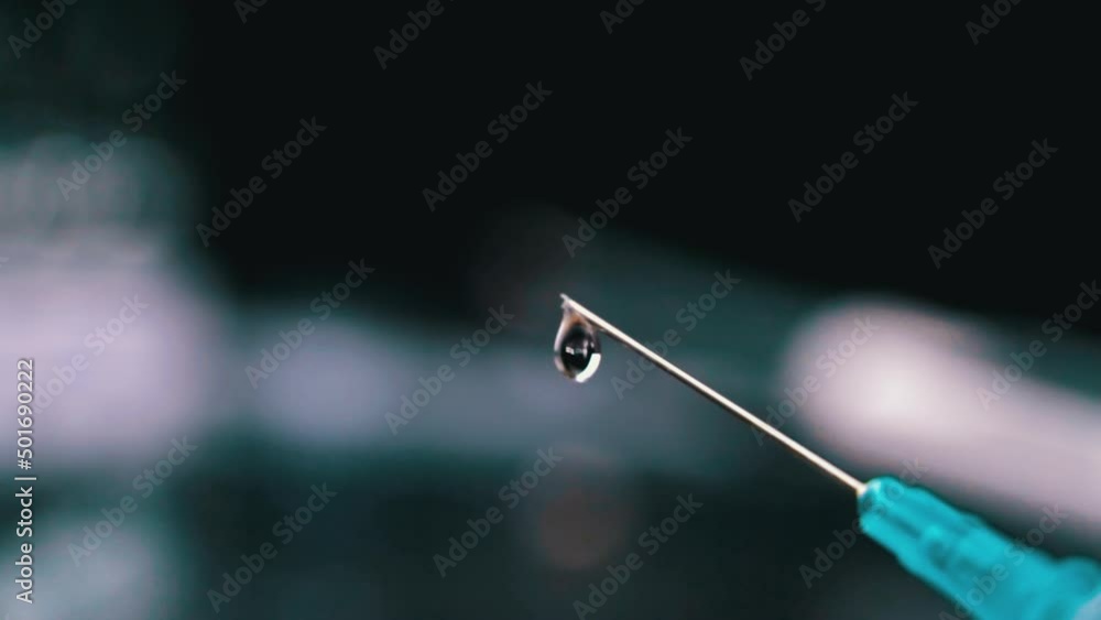 Video Stock Learstvo is dripping from medical syringe, flowing down in ...