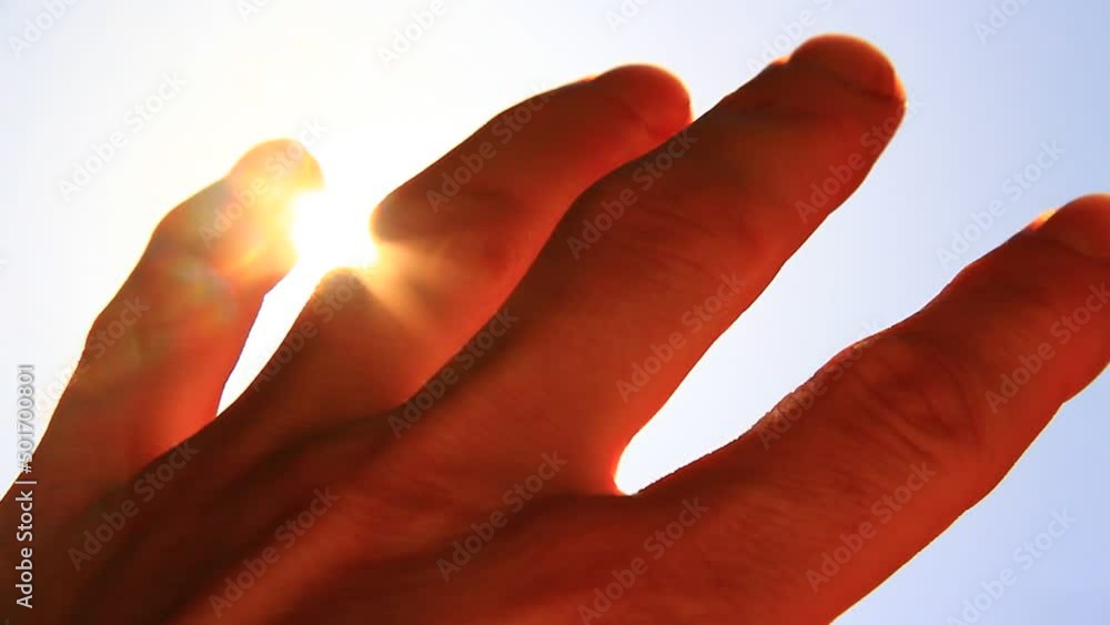 Try to cover hot sun with fingers. Stock Video | Adobe Stock