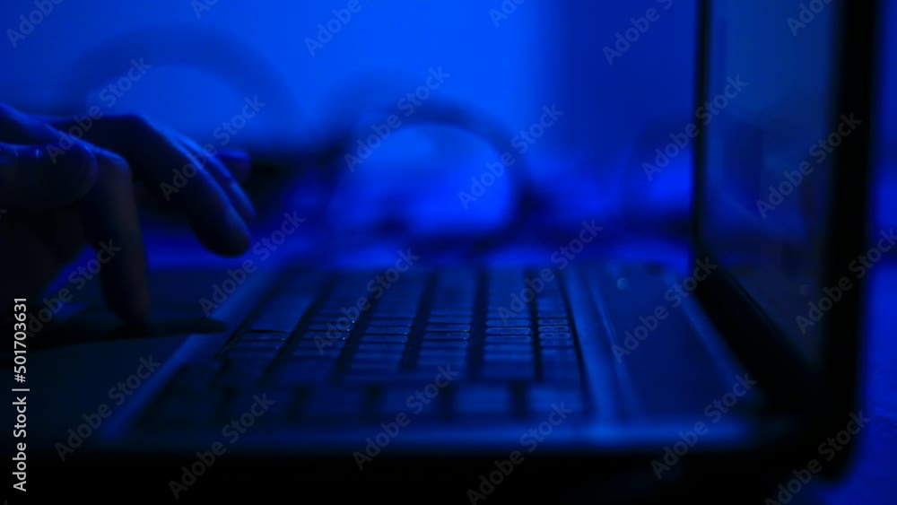 Conceptual palm hand in the blue darkness, doing gestures in front of ...