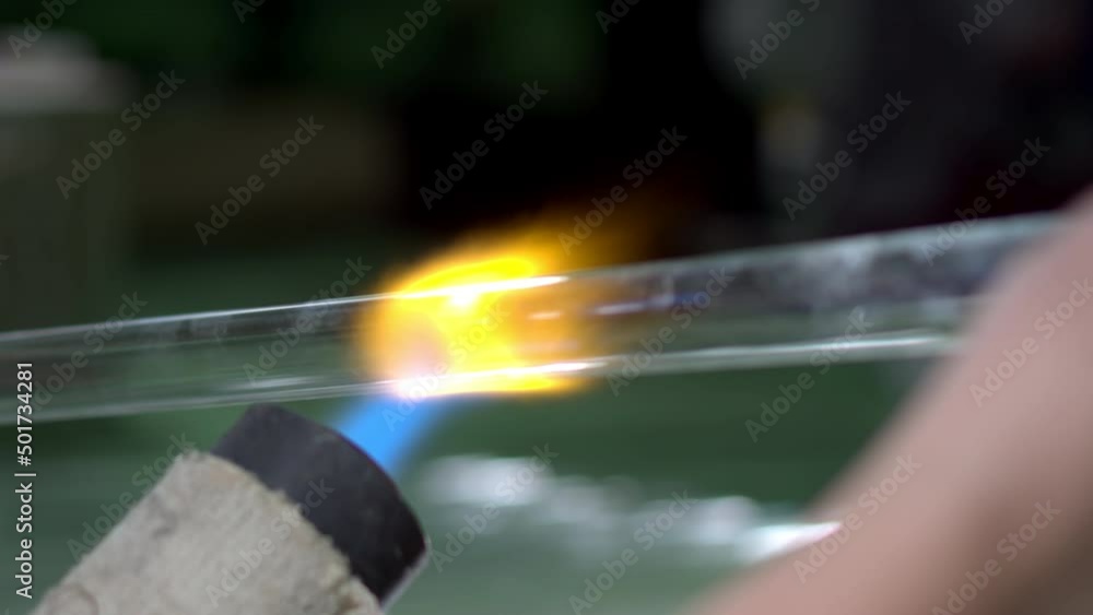 The technique of heating a glass tube on a gas burner, followed by ...