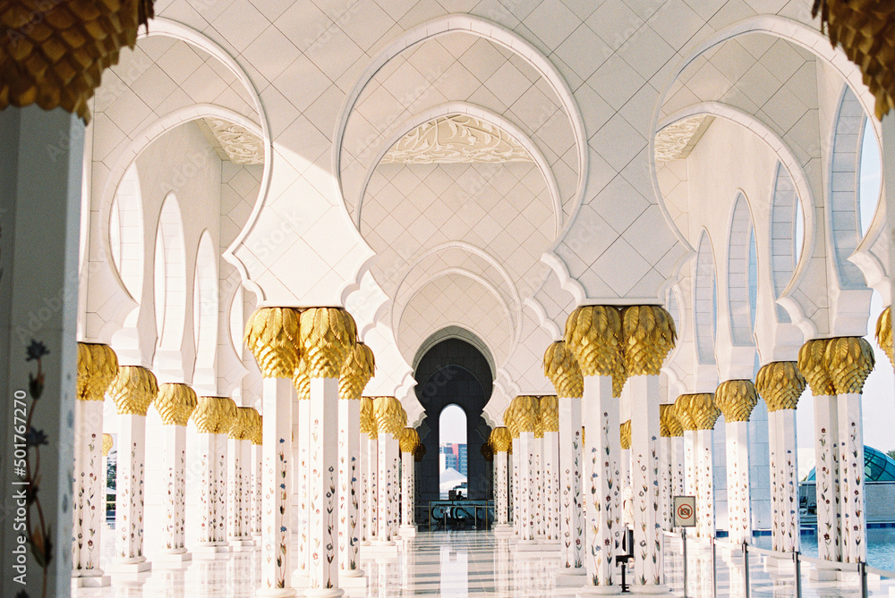 sun drenched empty halls of grand mosque with gilded columns Stock ...